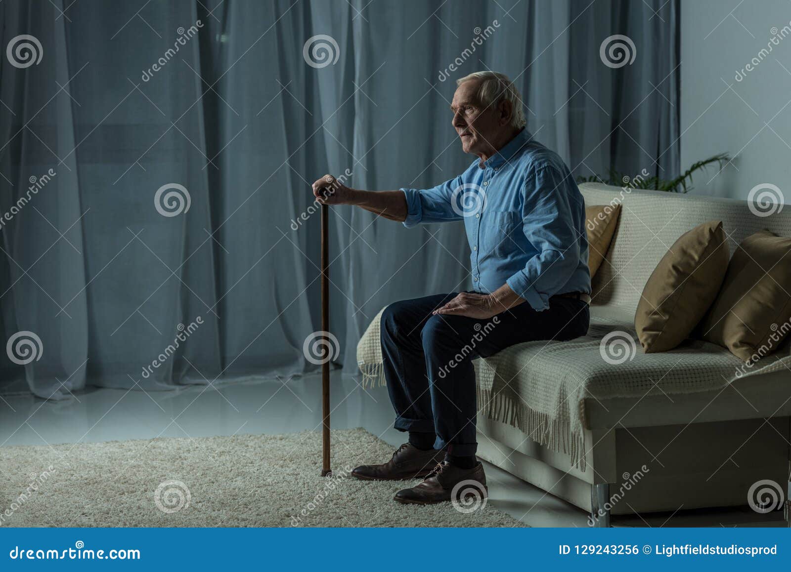 Senior Man Leans on a Cane while Sitting Stock Photo - Image of ...