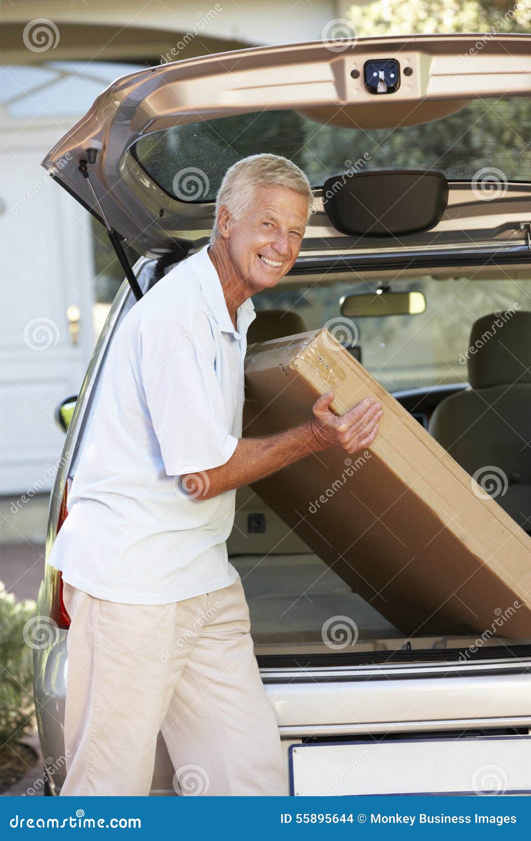 Senior Man Loading Large Package into Back of Car Stock Photo - Image ...