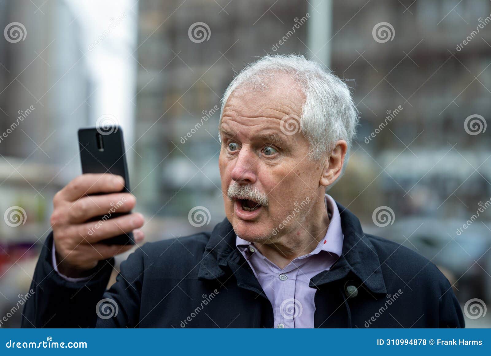 Senior Man Loocking in Shock at His Mobile Phone. Stock Photo - Image ...