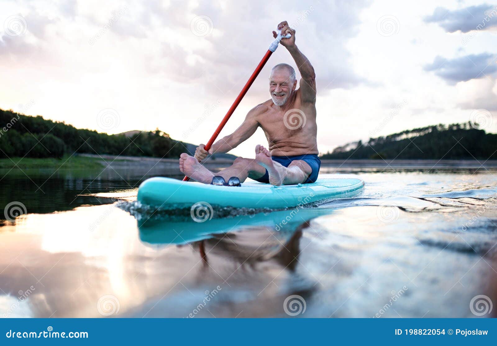 Senior Man Paddleboarding on Lake in Summer. Copy Space Stock Photo ...