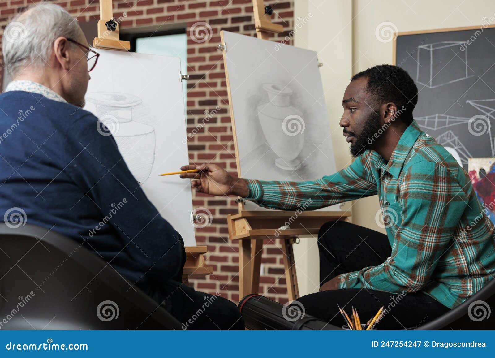 Senior Man Painter Supervising Young Student during Painting Class ...