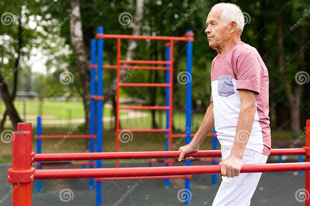 Senior Man Performing Parallel Bar Exercises in Park Stock Image ...