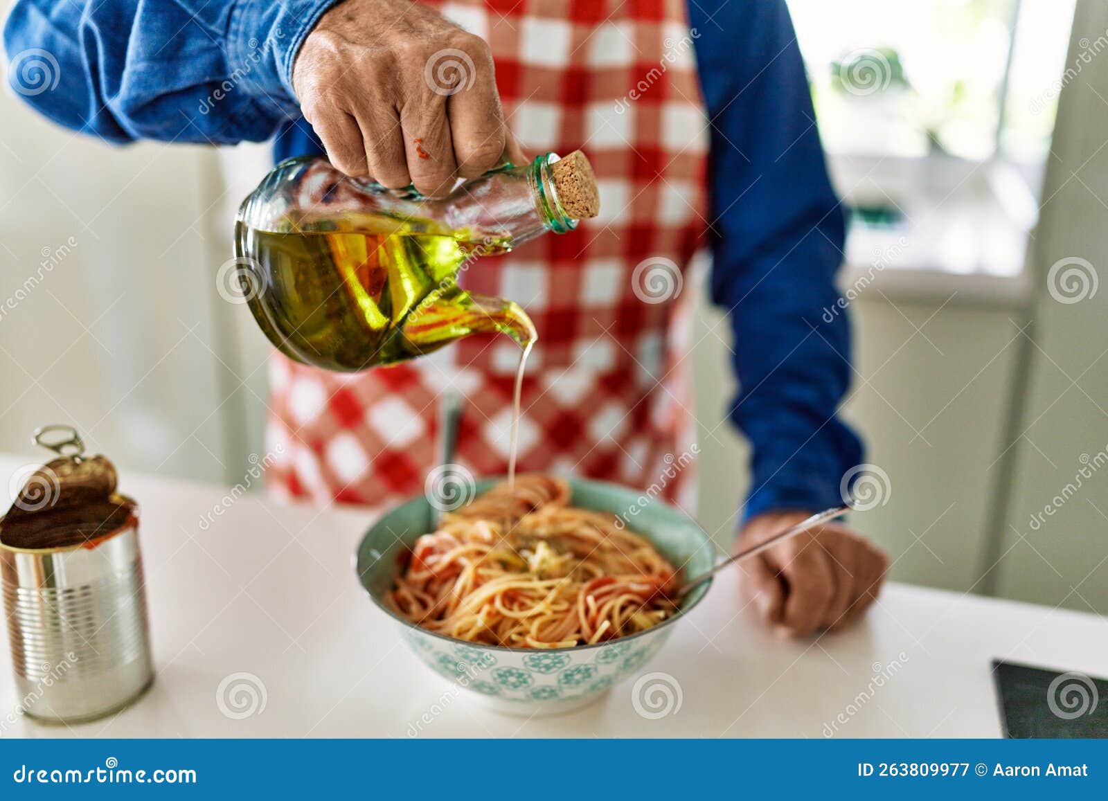Senior Man Pouring Oil on Spaghetti at Kitchen Stock Image - Image of ...