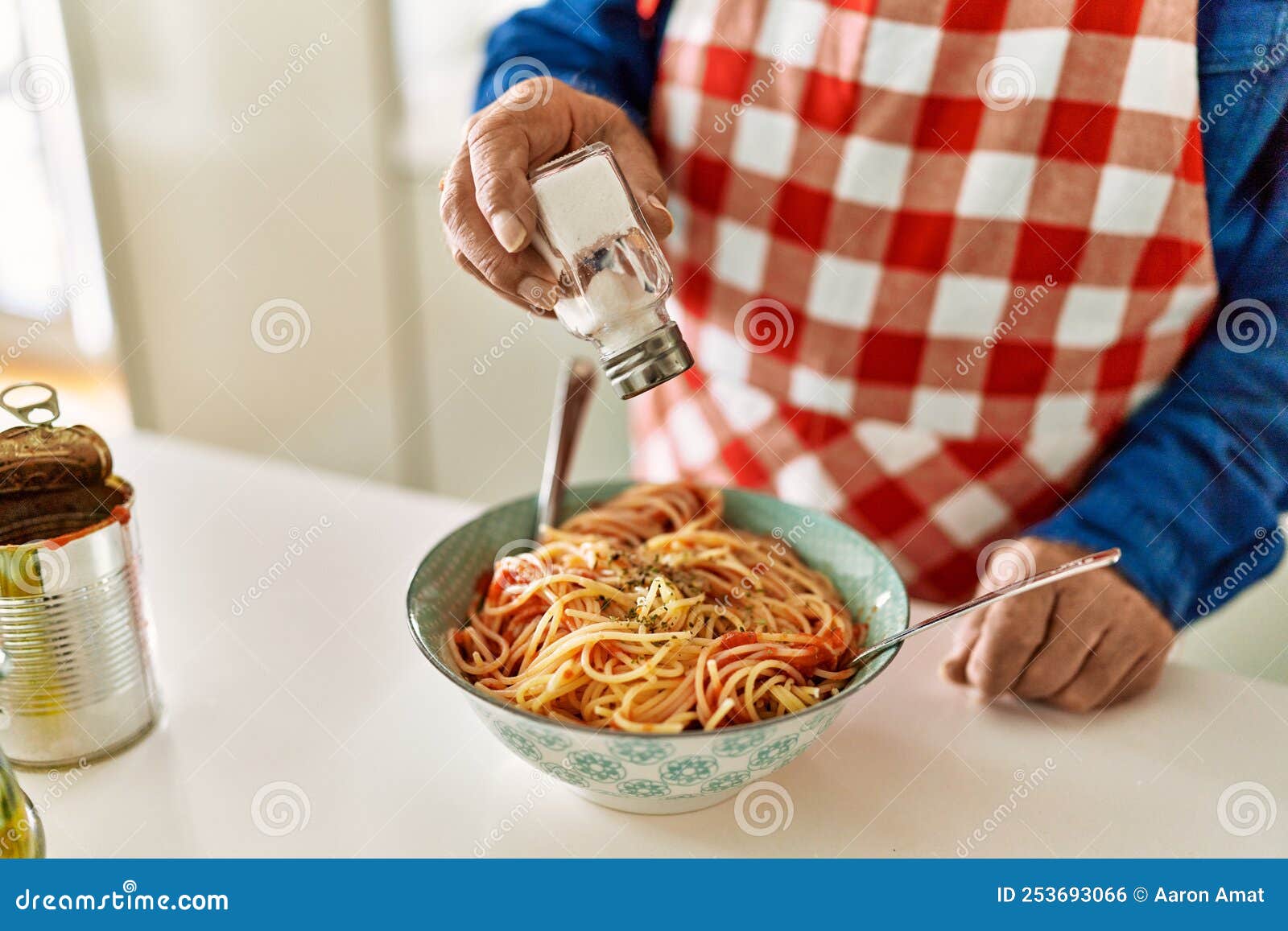 Senior Man Pouring Salt on Spaghetti at Kitchen Stock Photo - Image of ...