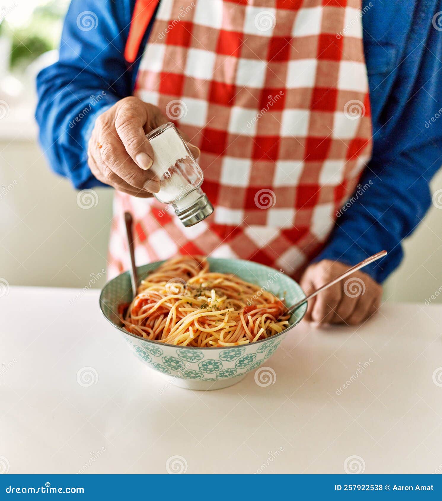 Senior Man Pouring Salt on Spaghetti at Kitchen Stock Photo - Image of ...