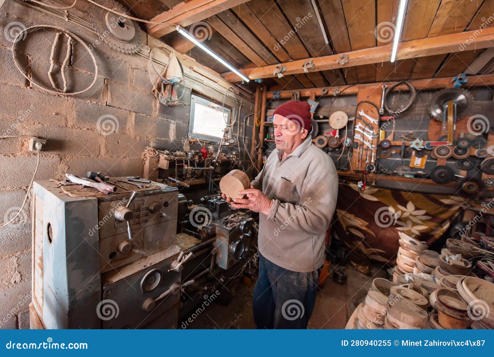 A Senior Man Processing Wooden Dishes in the Workshop in the ...
