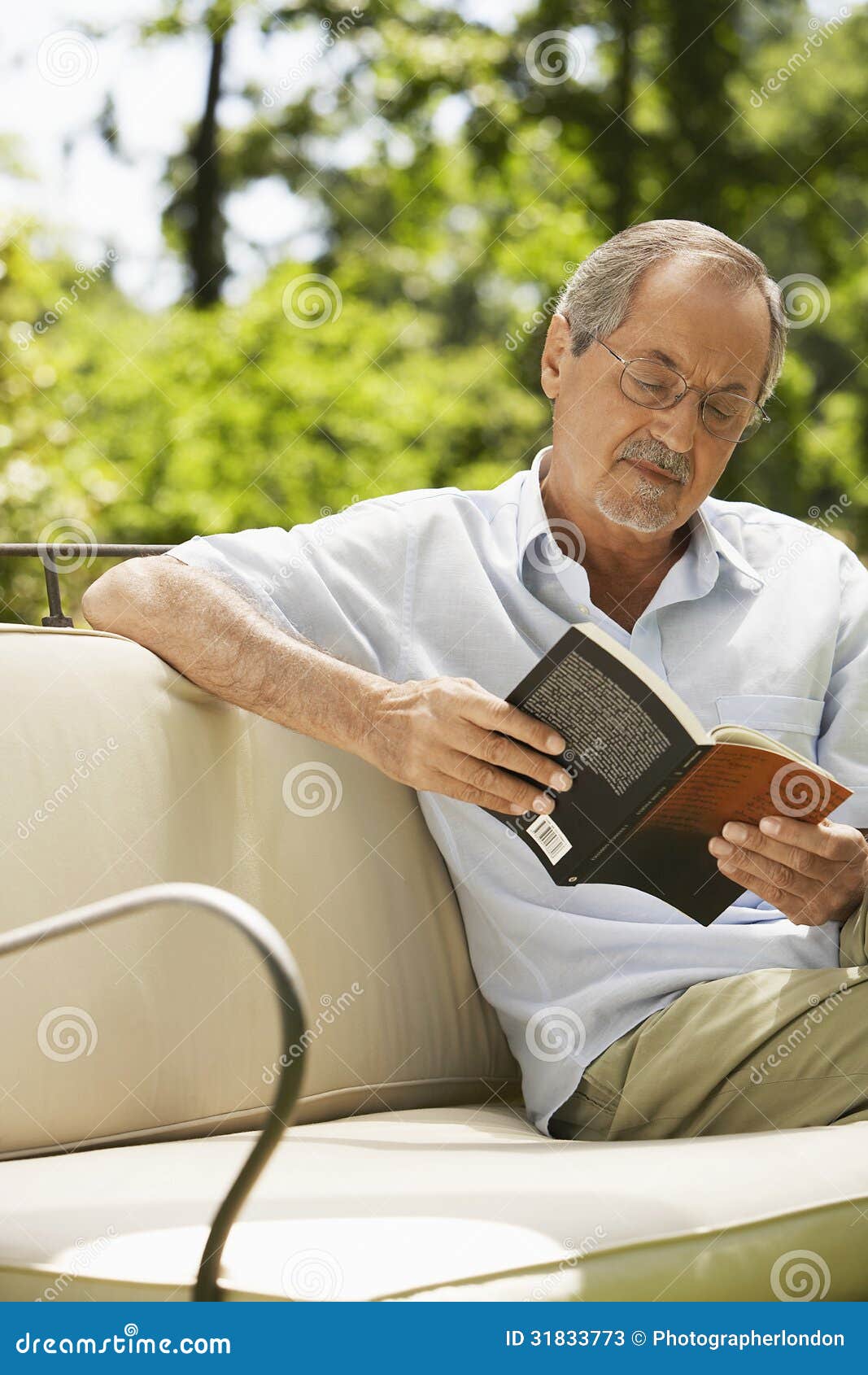 Senior Man Reading Book in Backyard Stock Image - Image of people ...