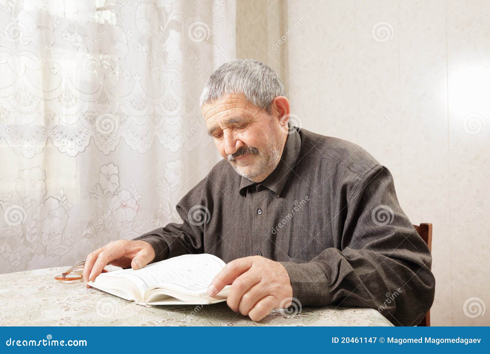 Senior Man Reading at Table Stock Image - Image of book, tablecloth ...