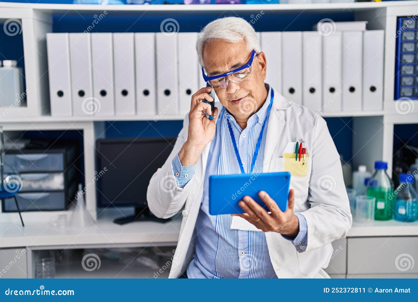 Senior Man Scientist Using Touchpad Talking on the Smartphone at ...