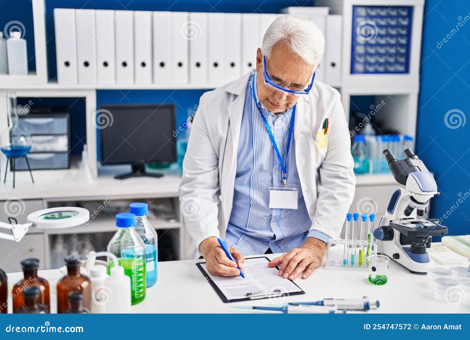 Senior Man Scientist Writing on Document at Laboratory Stock Photo ...