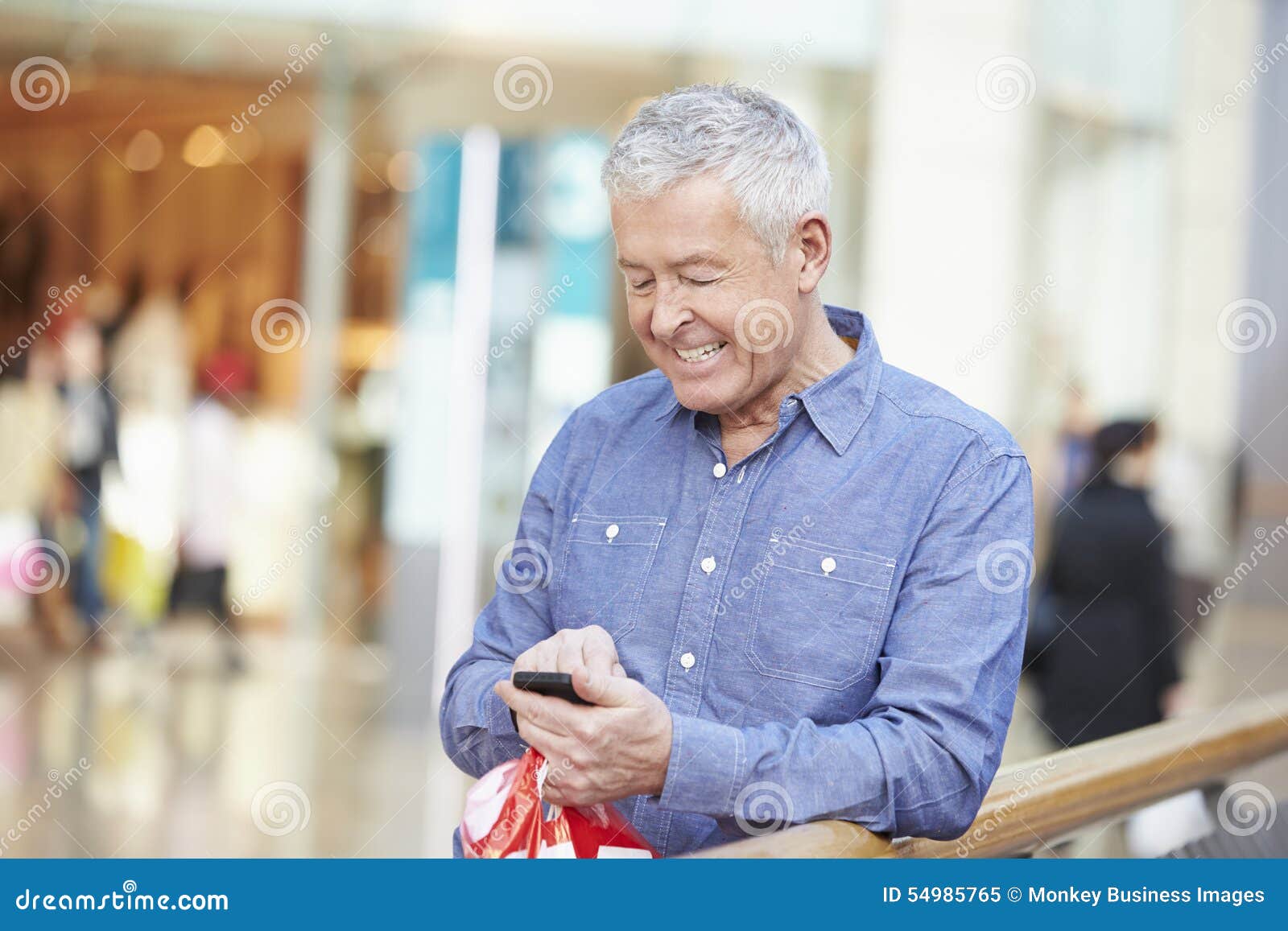 Senior Man in Shopping Mall Using Mobile Phone Stock Image - Image of ...
