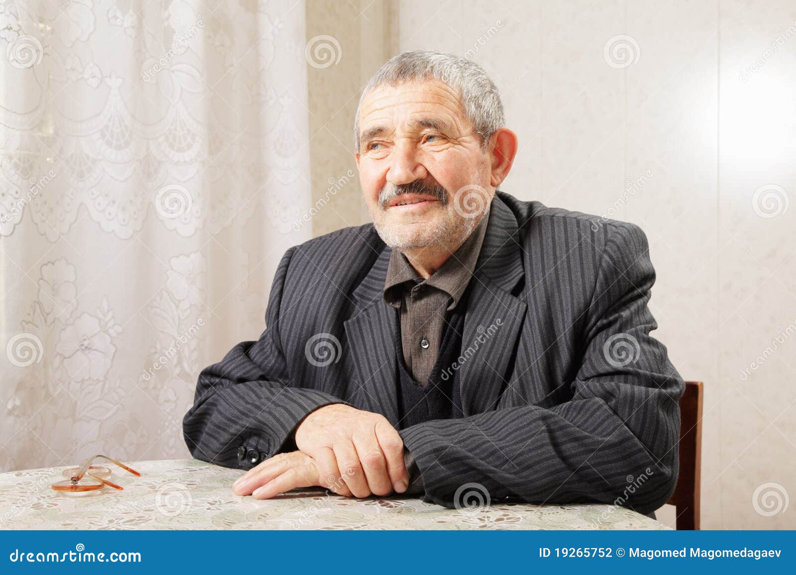 Senior Man Sitting at Table Stock Photo - Image of senior, pensive ...