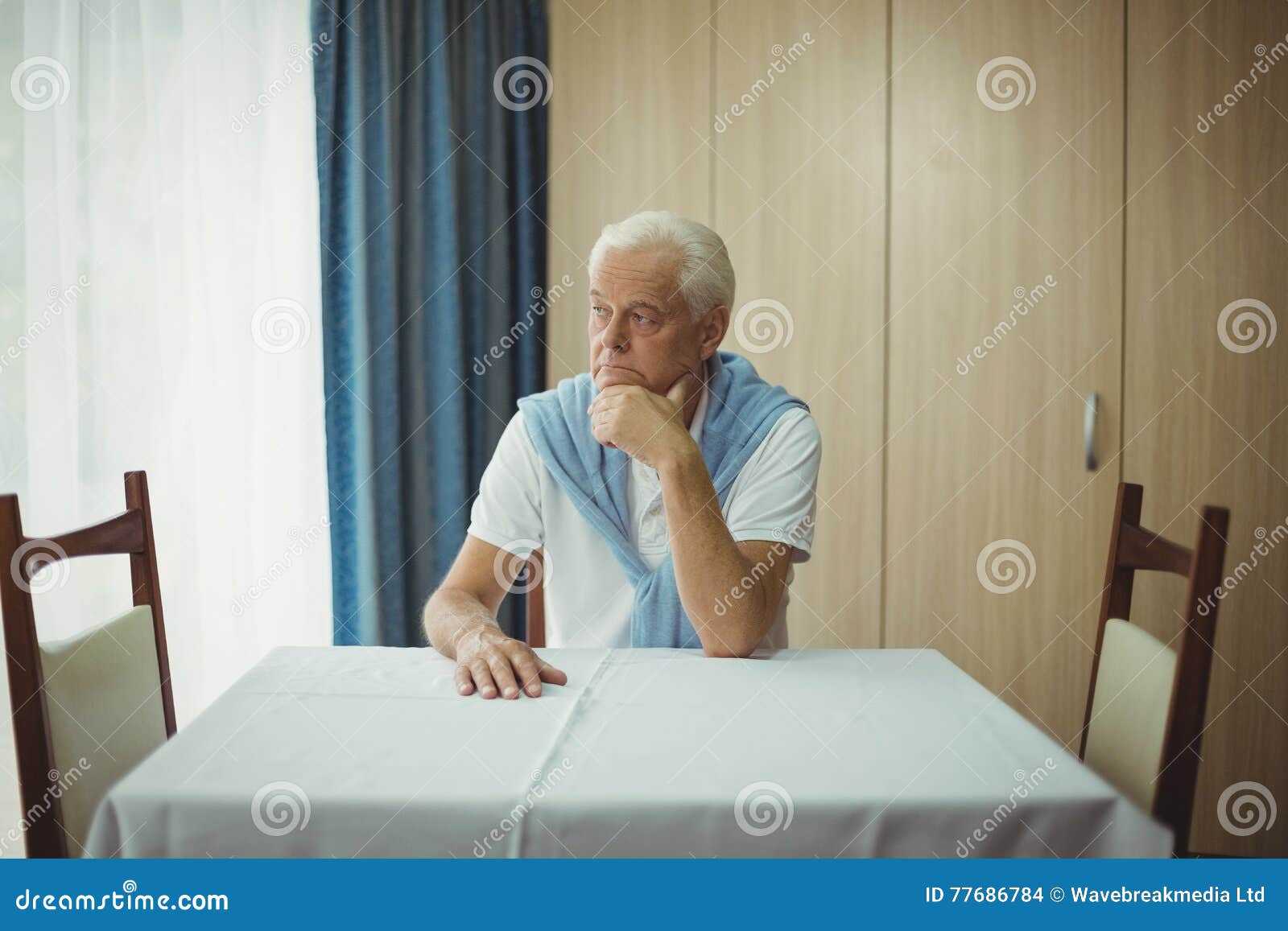 Senior Man Sitting at a Table Stock Photo - Image of dreariness, health ...