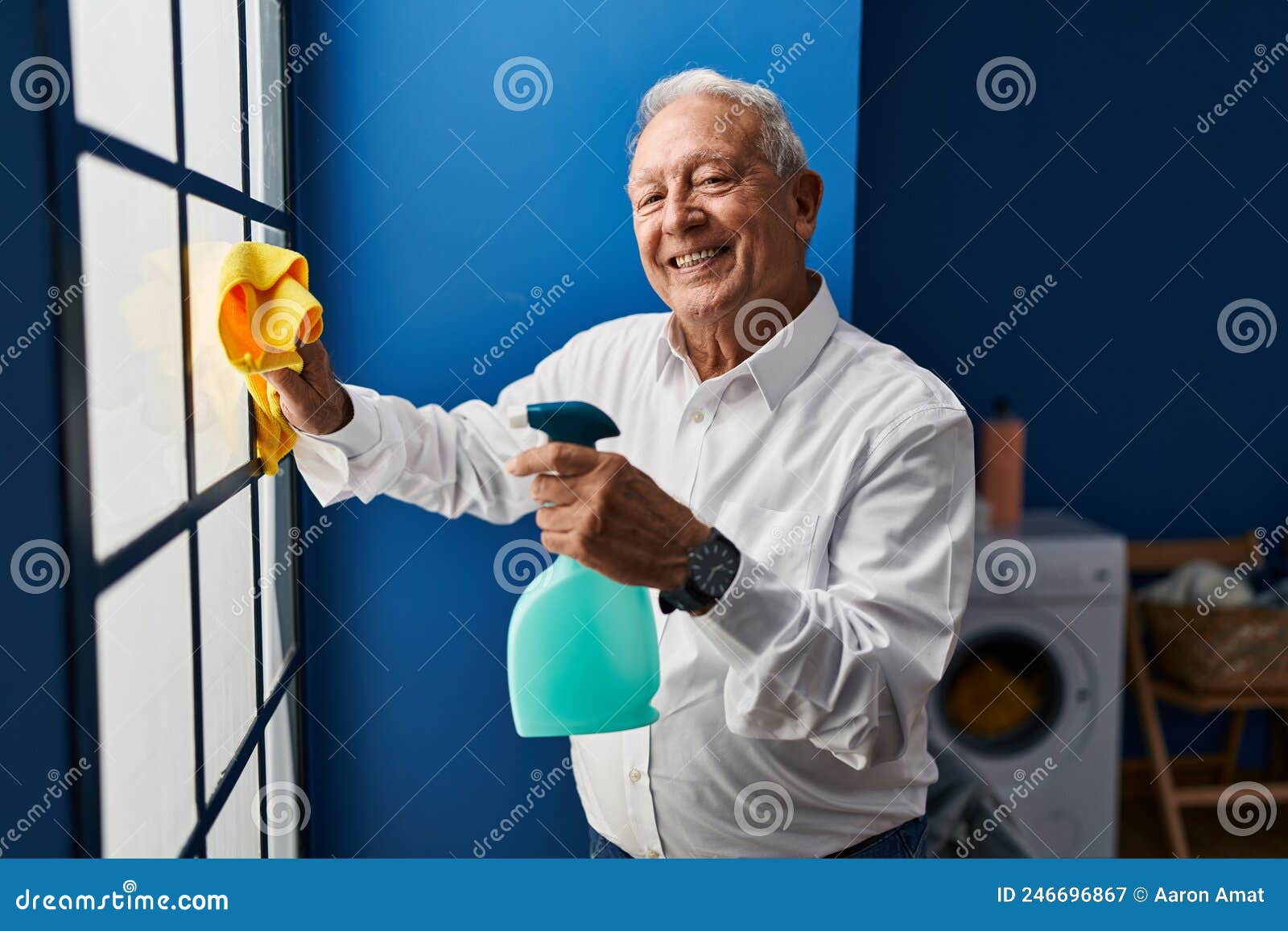 Senior Man Smiling Confident Cleaning Window at Laundry Room Stock ...