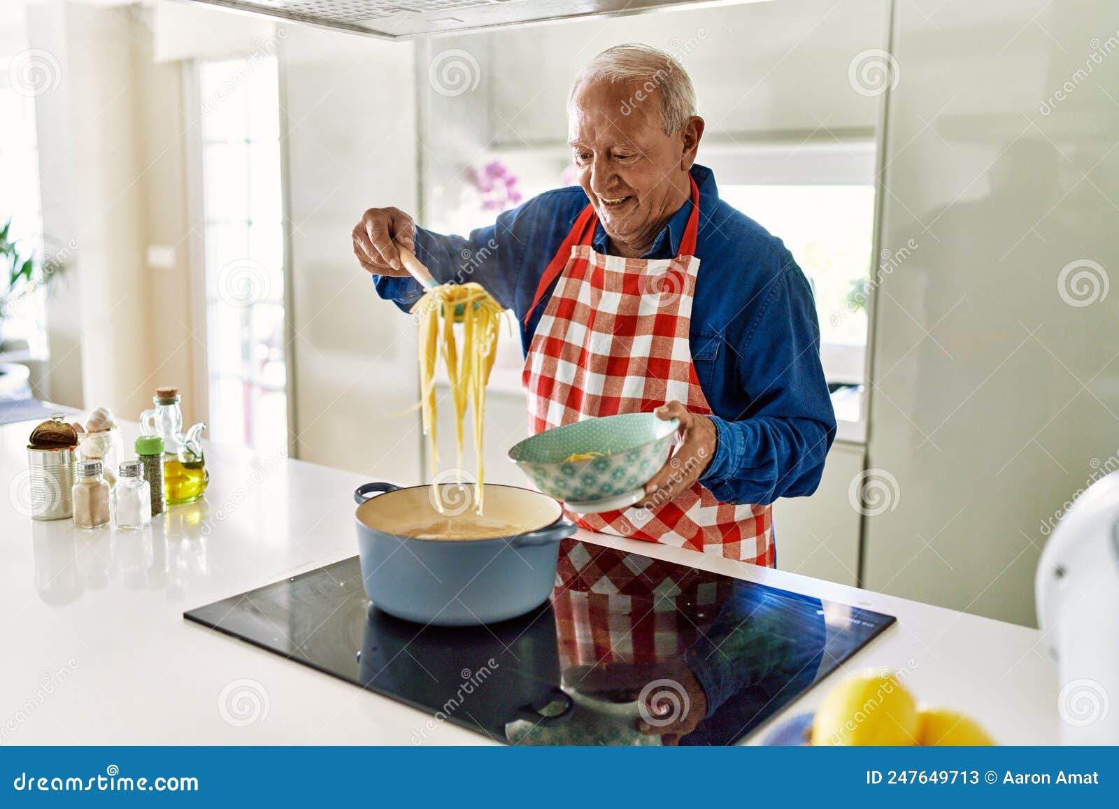 Senior Man Smiling Confident Cooking Spaghetti at Kitchen Stock Image ...