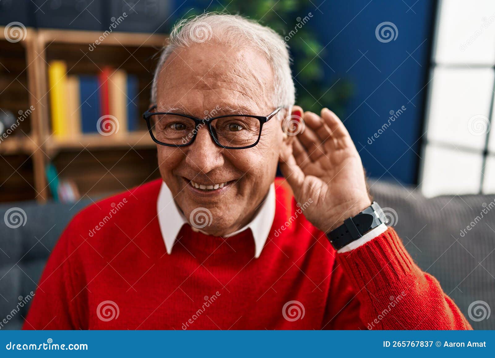 Senior Man Smiling Confident Using Deafness Hearing Aid at Home Stock ...