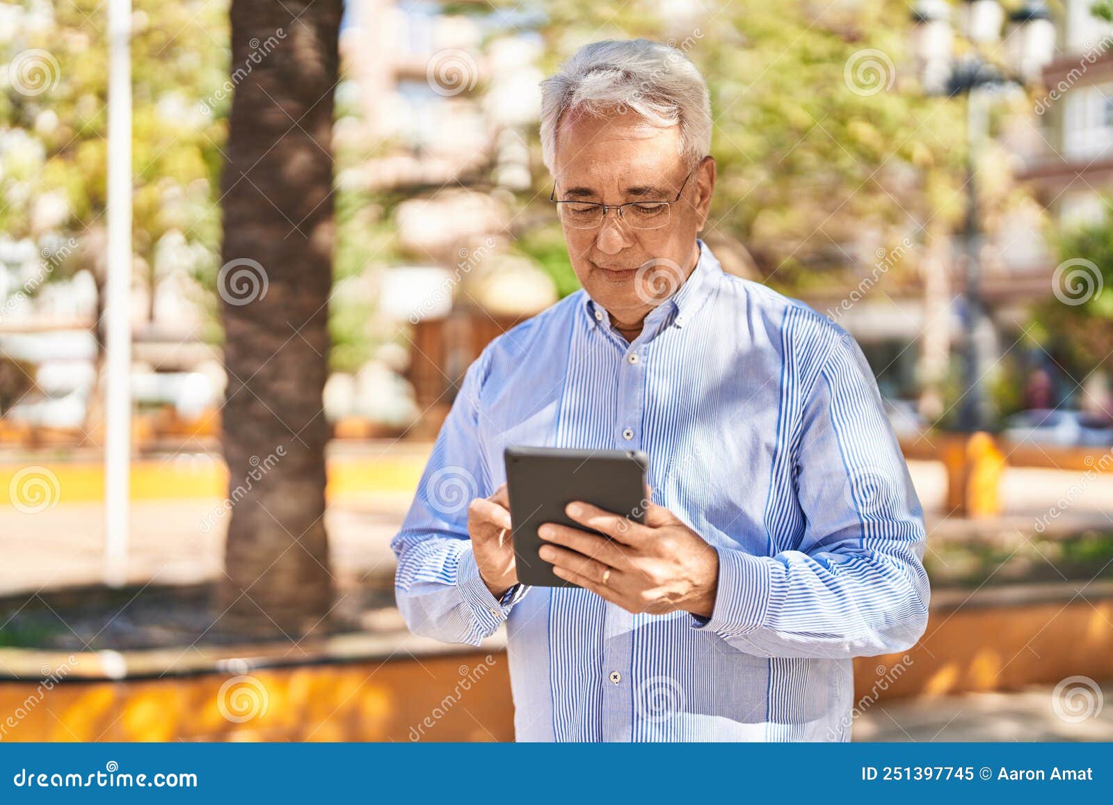 Senior Man Smiling Confident Using Touchpad At Park Stock Image Image