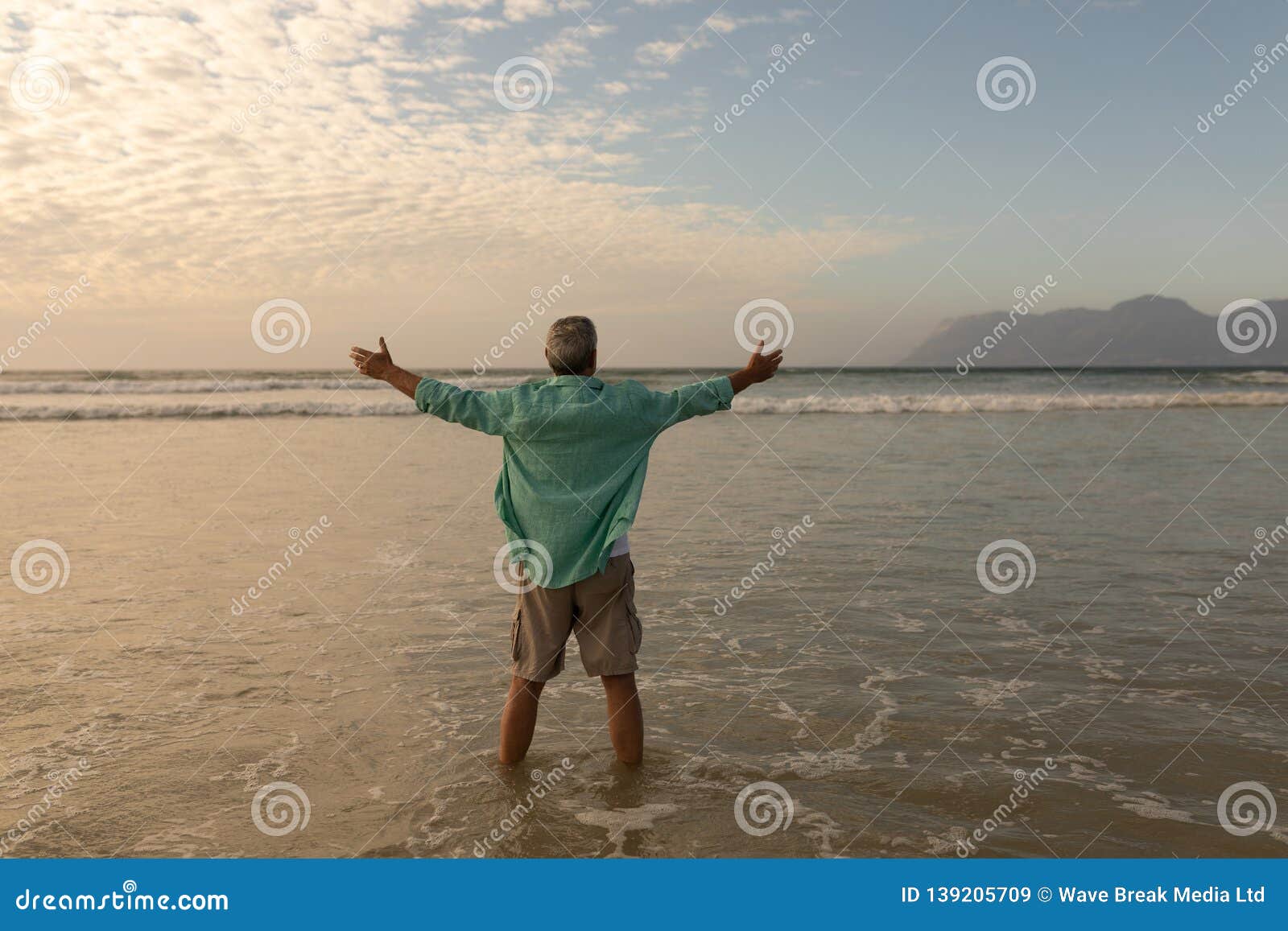 Senior Man Standing with Arms Outstretched on the Beach Stock Image ...