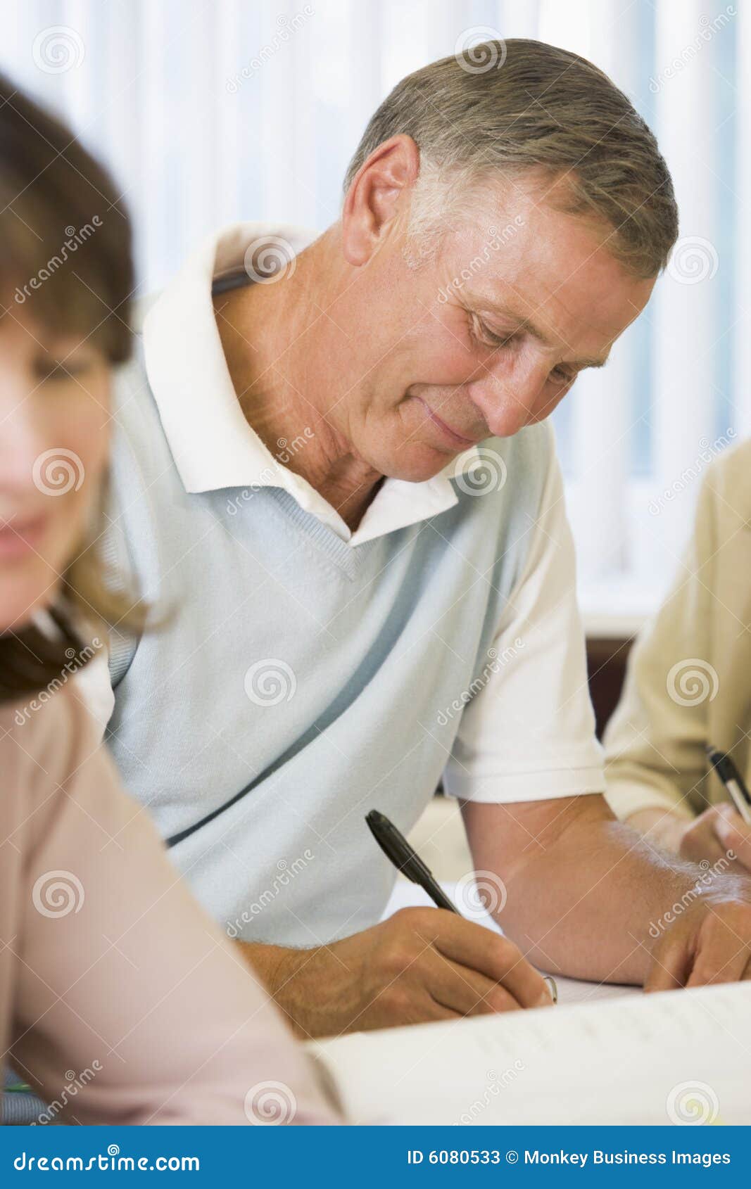 Senior Man Studying with Other Students Stock Image - Image of paper ...