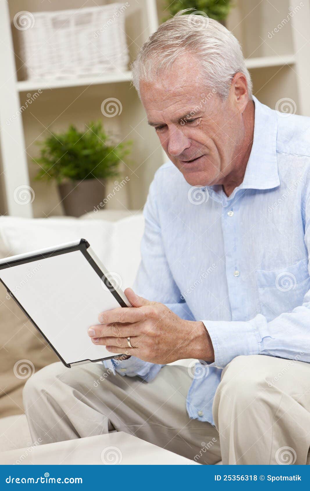 Senior Man Using Tablet Computer at Home Stock Photo - Image of sitting ...