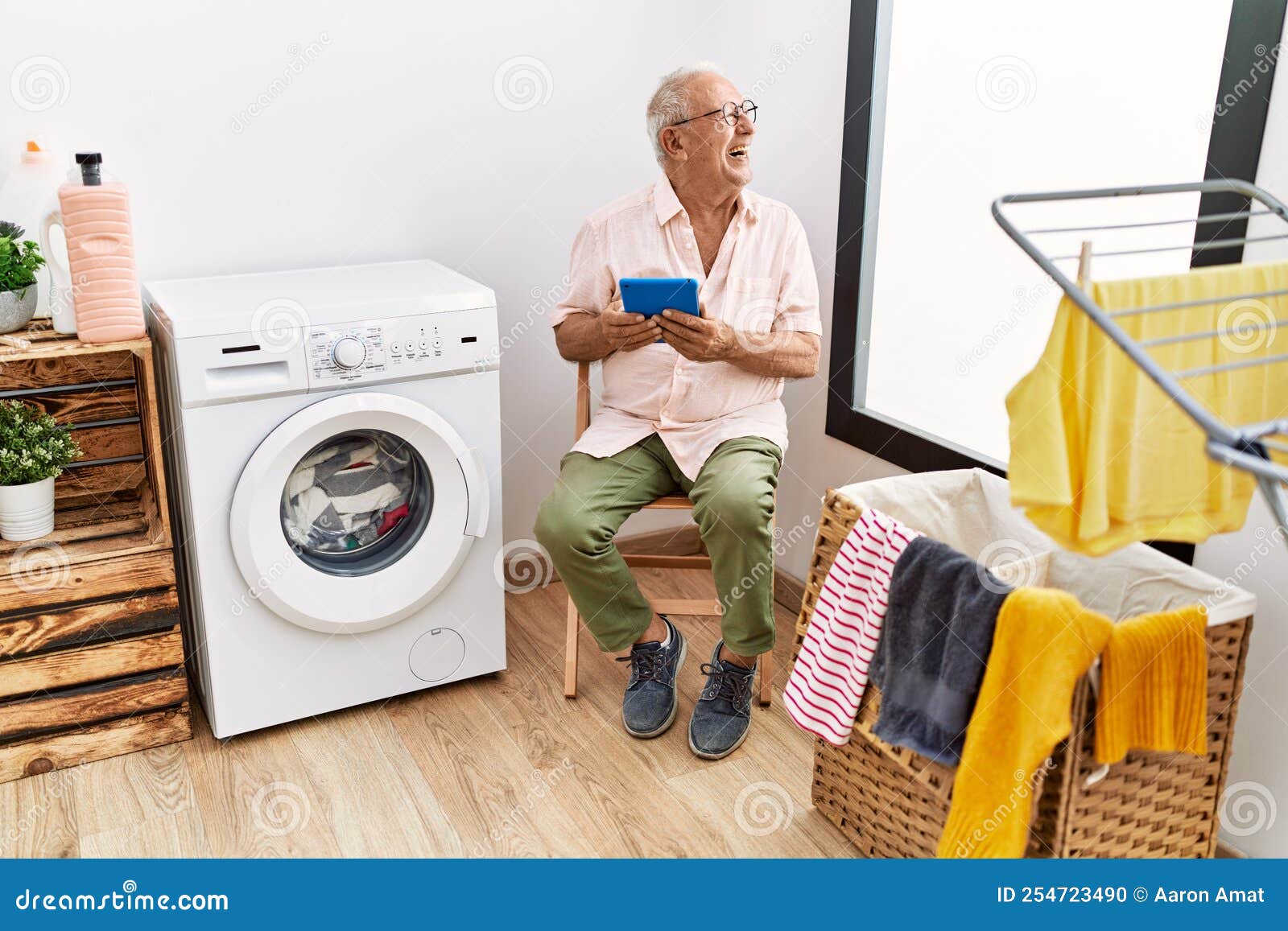 Senior Man Using Touchpad Waiting for Washing Machine at Laundry Room ...