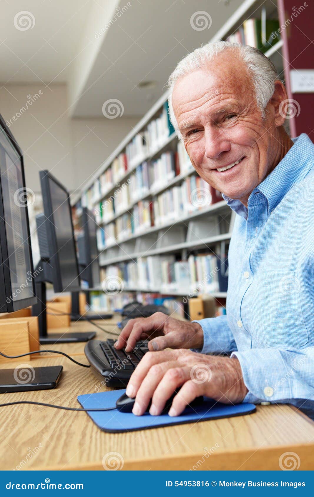 Senior Man Working on Computer in Library Stock Photo - Image of ...