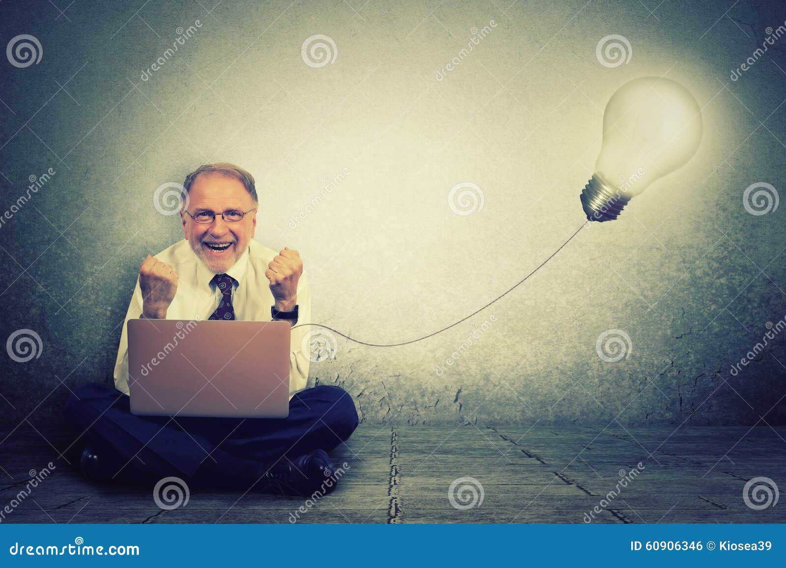 Senior Man Working on Computer with Light Bulb Plugged in it Stock ...