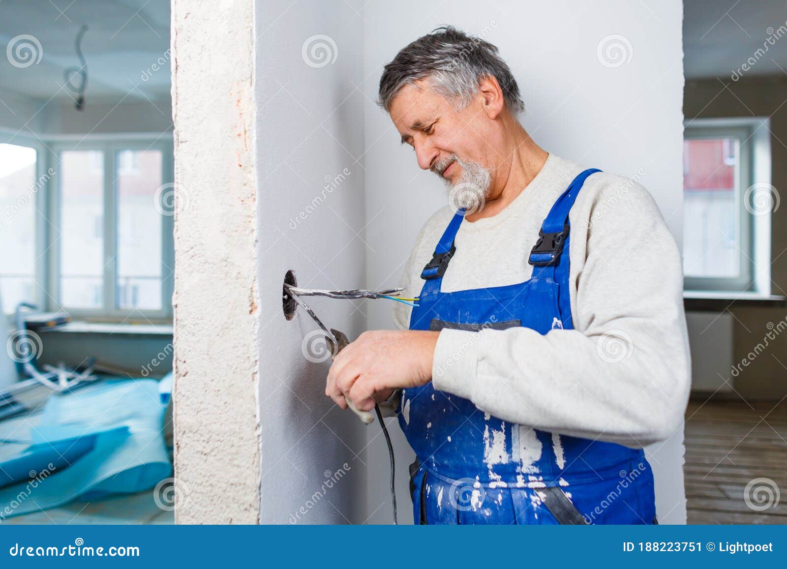 Senior Man Working on the Electrical Installations in Appartment Stock ...
