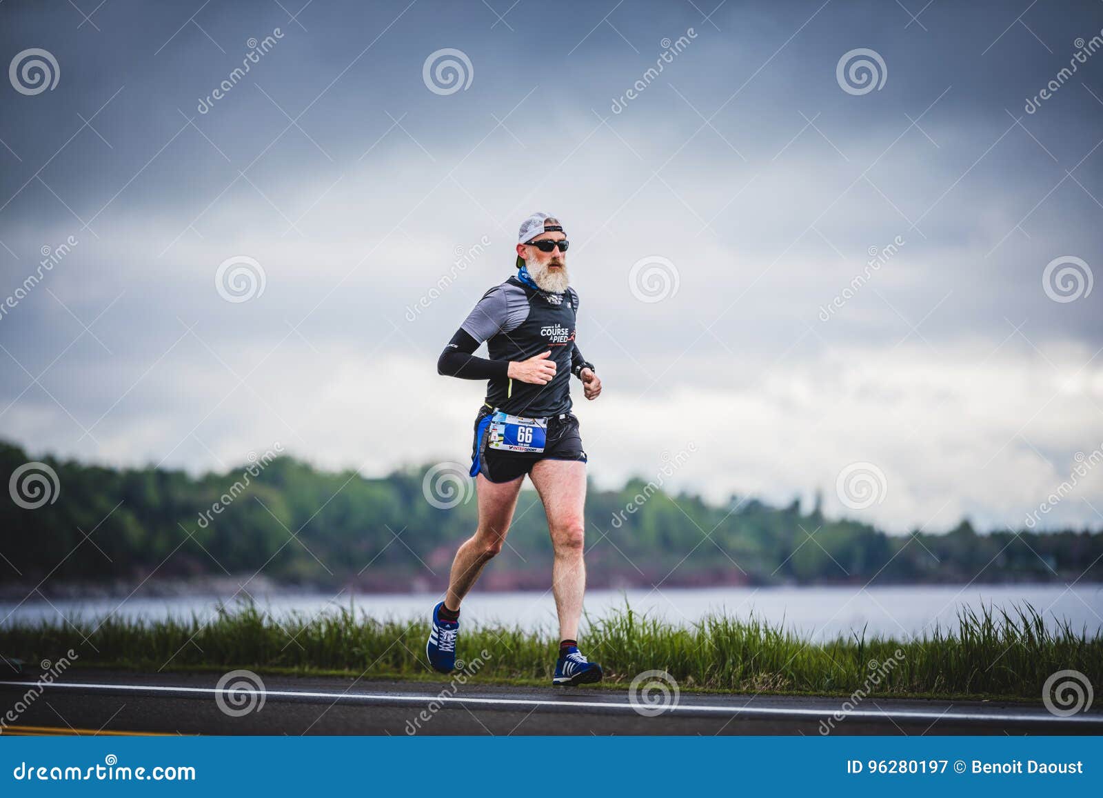 Senior Marathoner Alone on the Side of the Road and Ocean Editorial ...