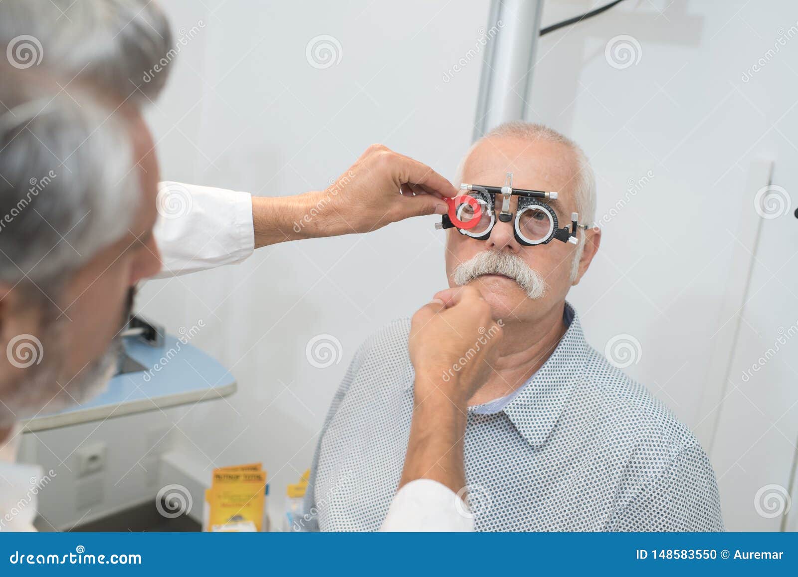 Senior man doing eye test stock photo. Image of aging - 148583550
