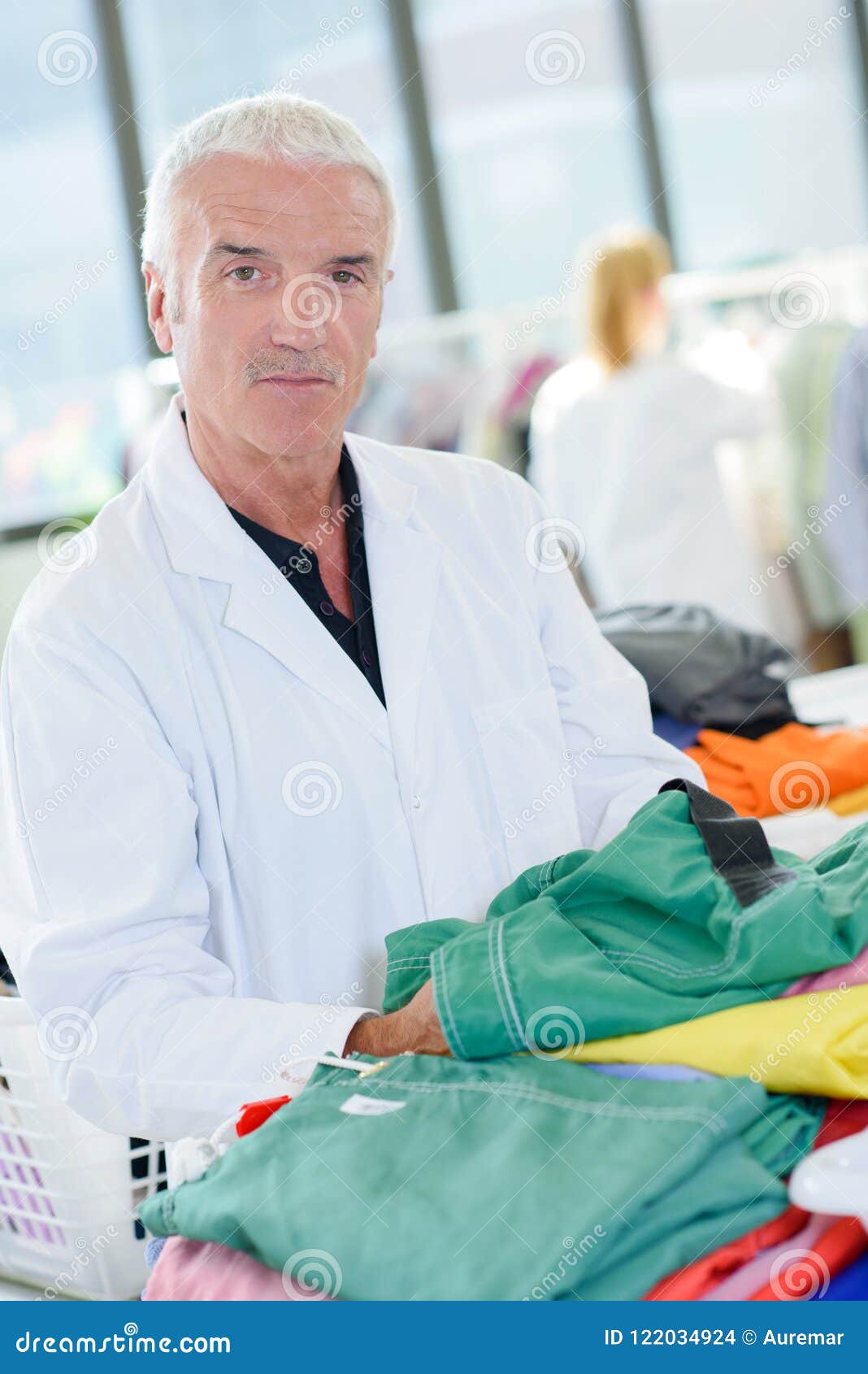 Senior man sorting laundry stock photo. Image of employment - 122034924
