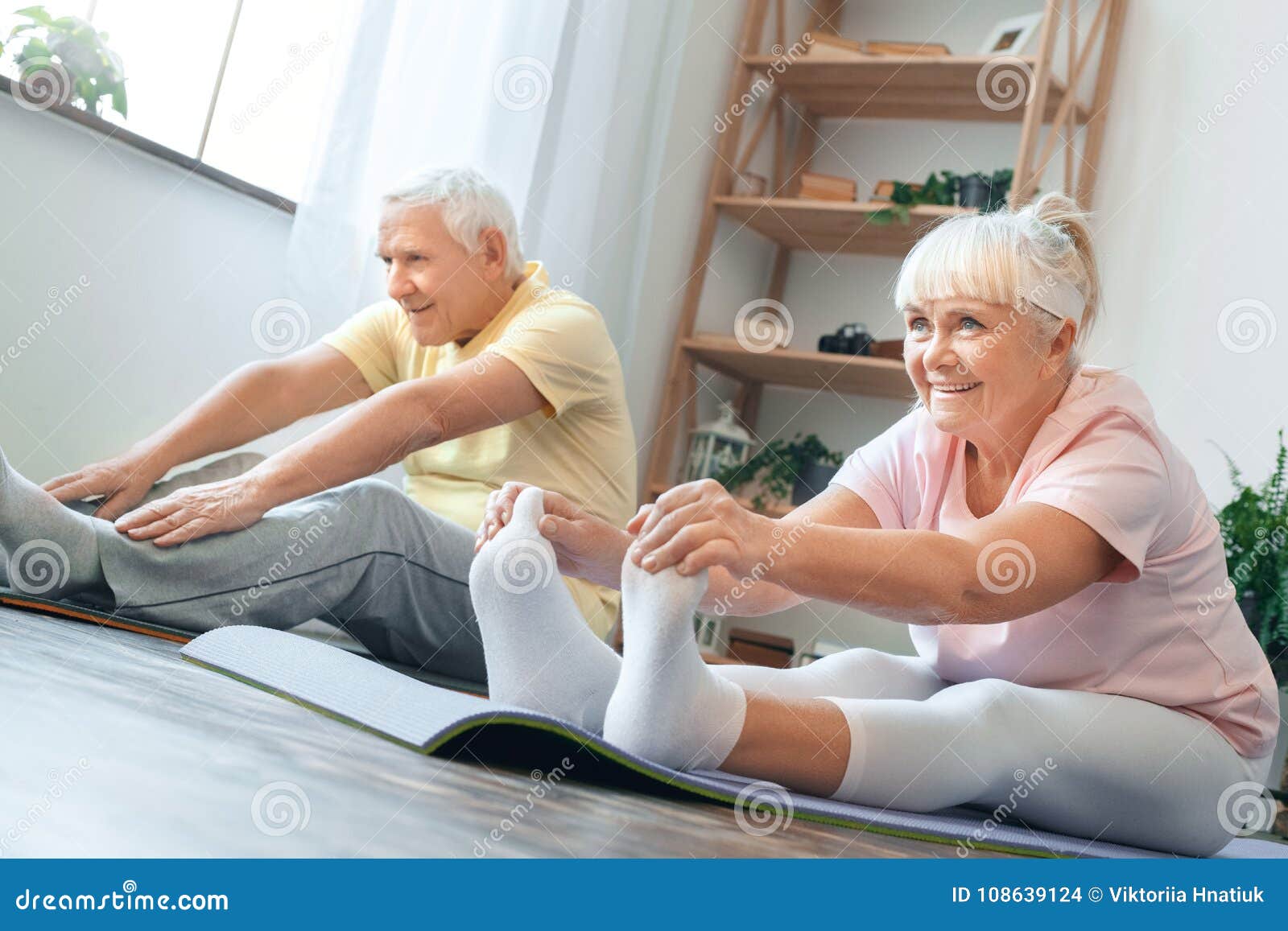 Senior Couple Doing Yoga Together at Home Health Care Legs Stretching ... Senior Couple Doing Yoga Together at Home Health Care Legs Stretching ...