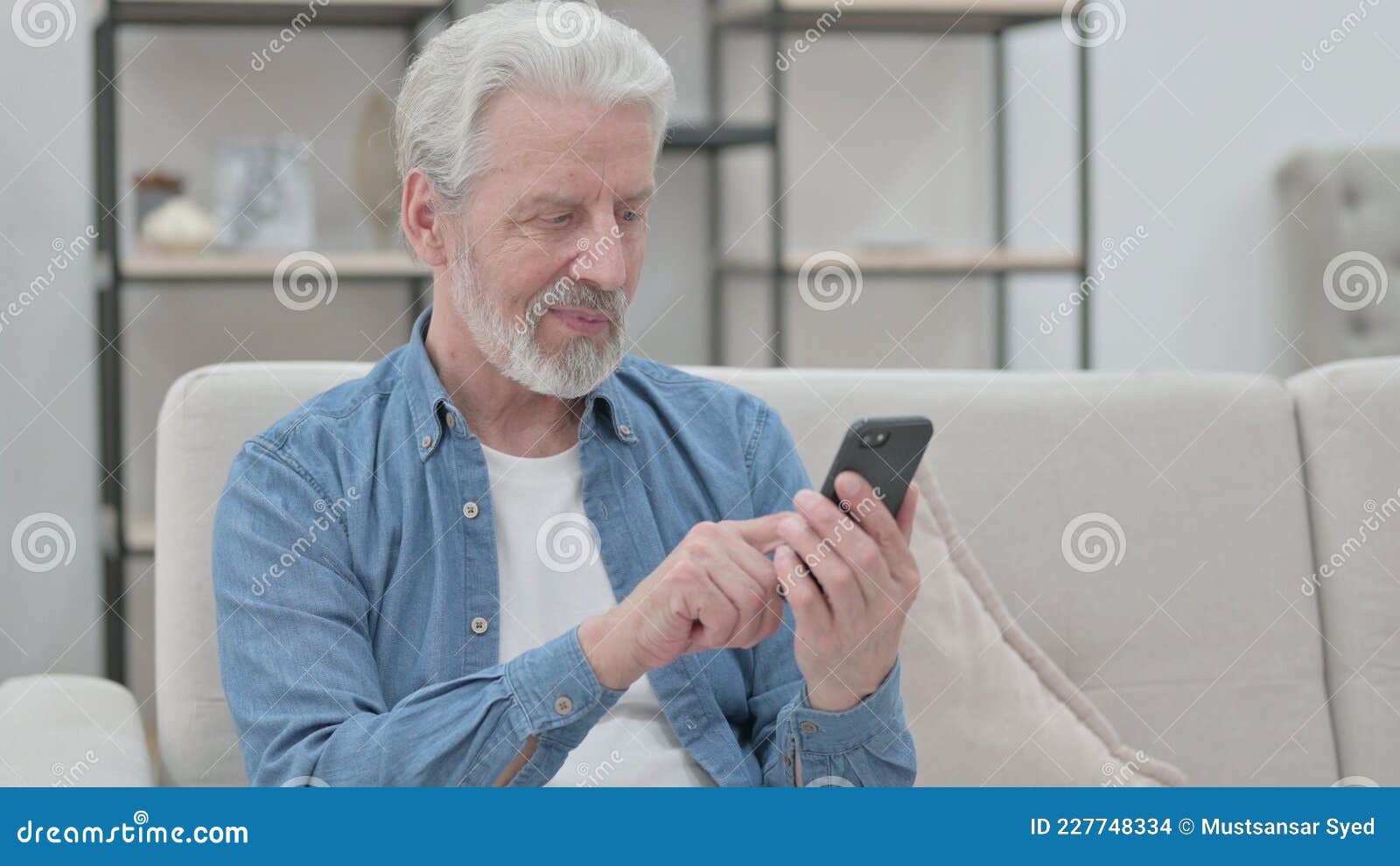 Old Man Using Smartphone while Sitting on Sofa Stock Photo - Image of ...