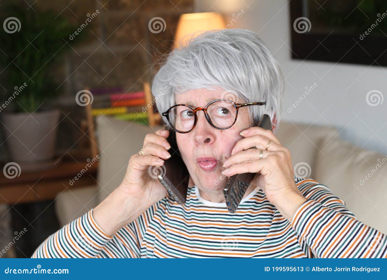 Senior Overwhelmed Woman Using Two Cellphones Stock Image - Image of ...
