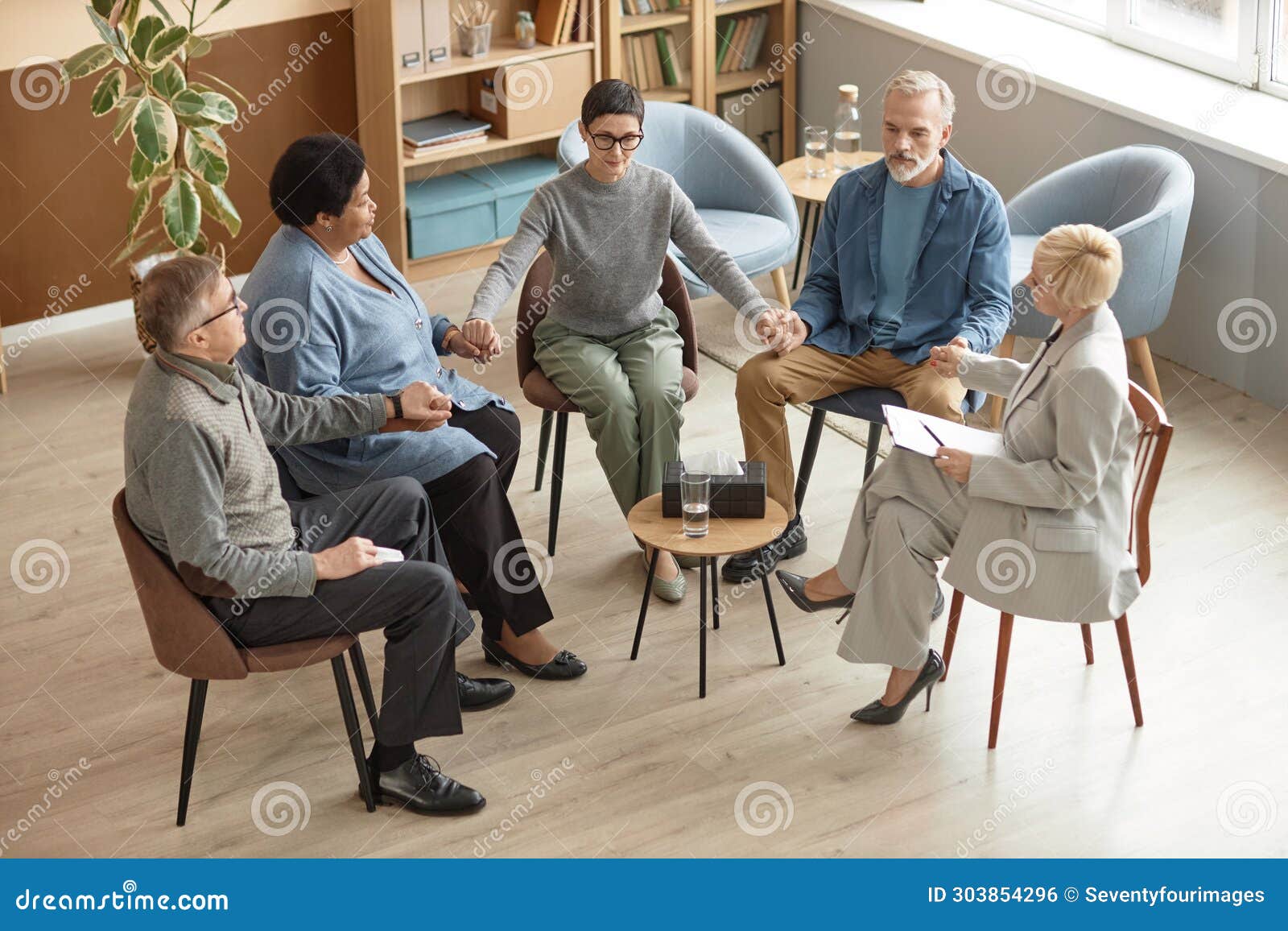 Senior People Holding Hands in Therapy Session Stock Photo - Image of ...