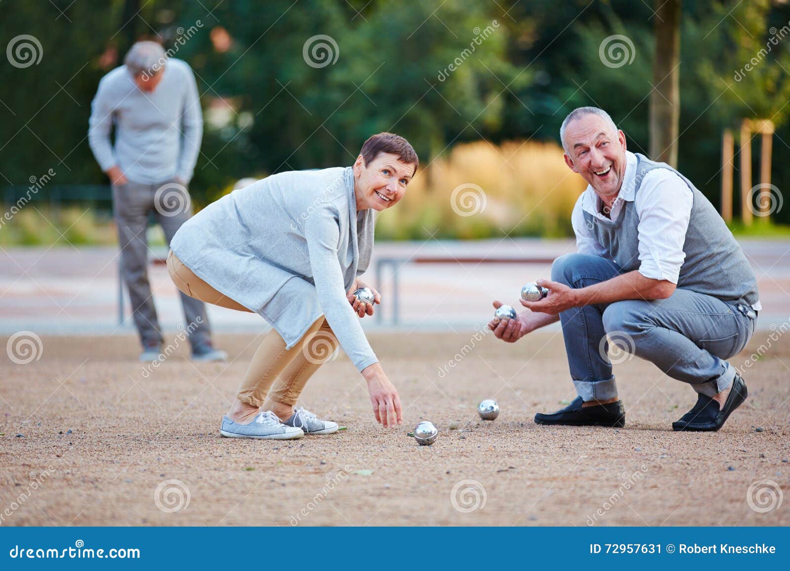 Senior People Playing Boule Lifting Up Balls Stock Image - Image of ...