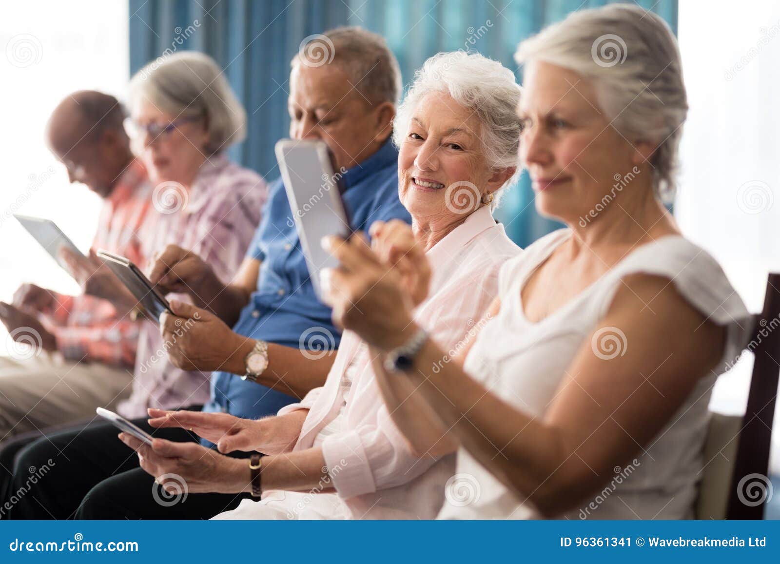 Senior People Sitting on Chairs while Using Digital Tablets Stock Image ...