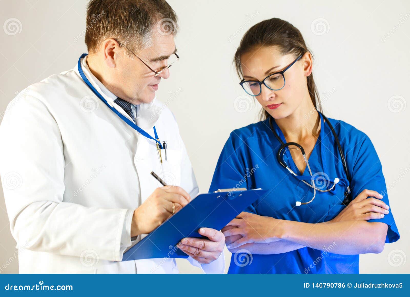 Senior Physician Tests the Knowledge of the Young Doctor Stock Photo ...