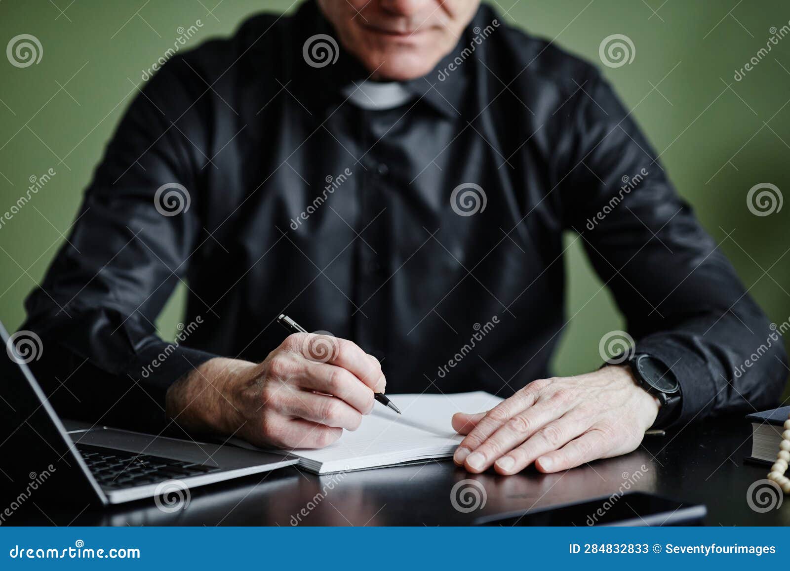 Senior Priest Writing in Notebook at Desk Working on Speech in Office ...