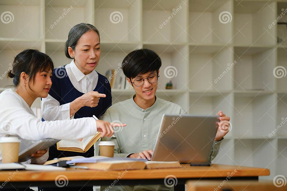 Senior Professor Explaining Something To Students during Class at ...