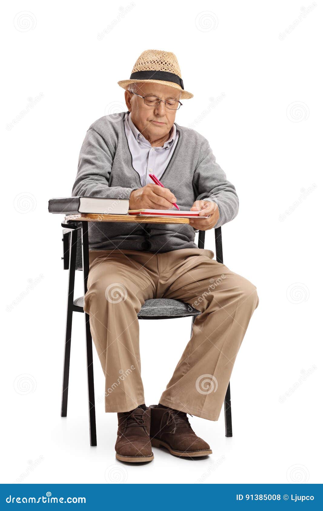 Senior Sitting in a School Chair and Taking Notes Stock Photo - Image ...