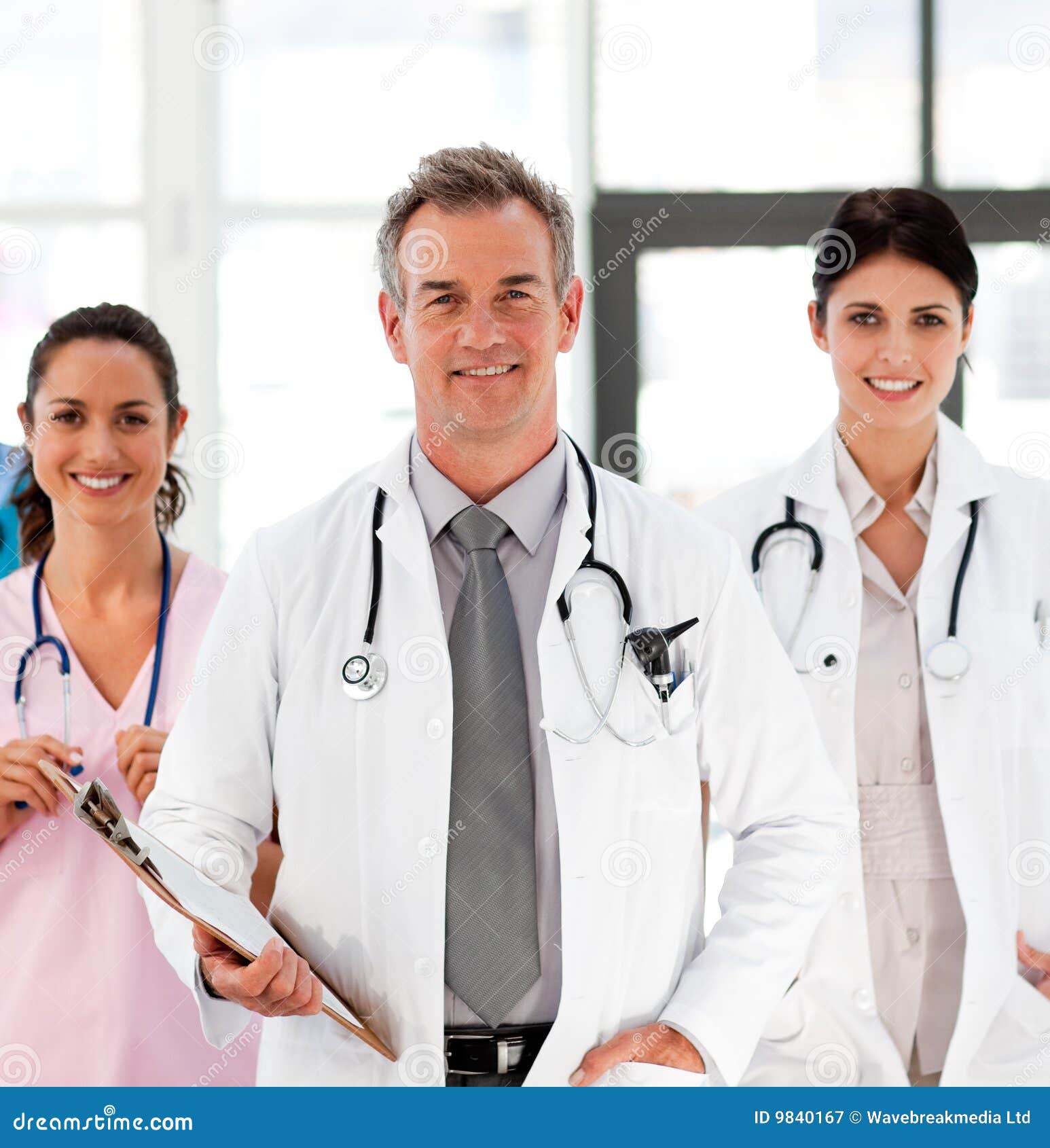 Senior Smiling Doctor with His Colleagues Stock Image - Image of ...