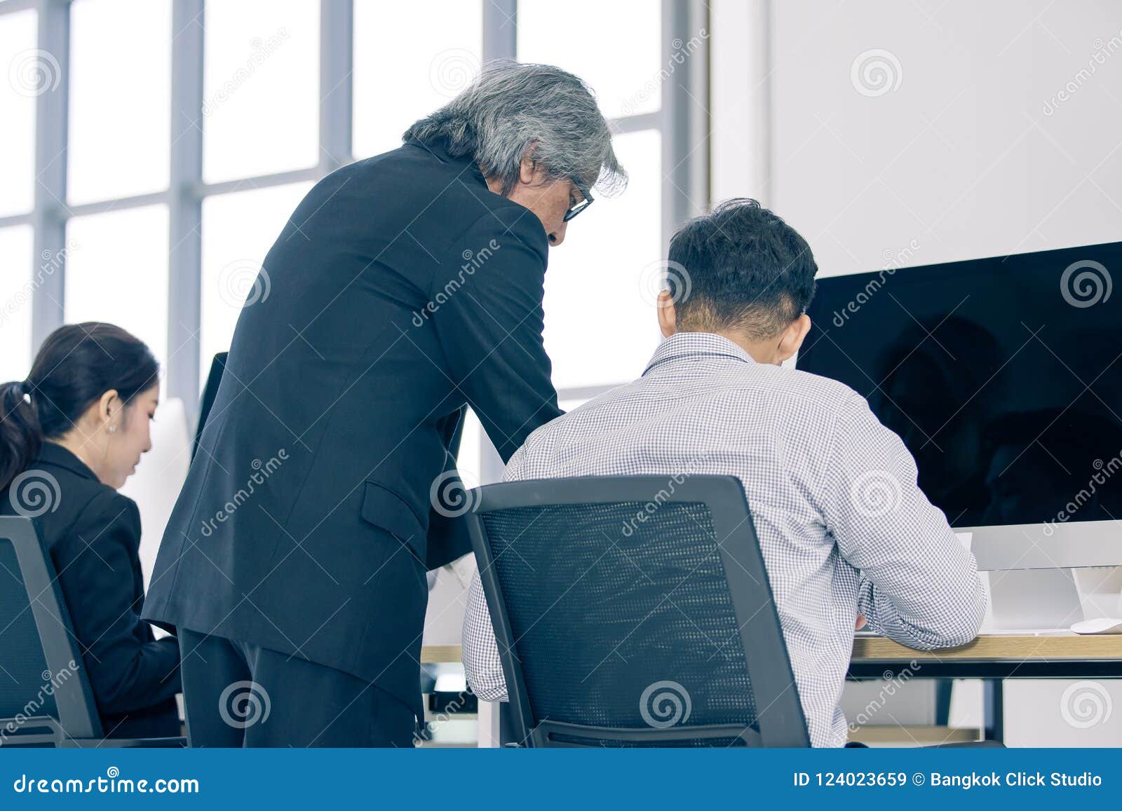 Senior Staff in Suit is Ordering a Man Employee To View a Computerized ...