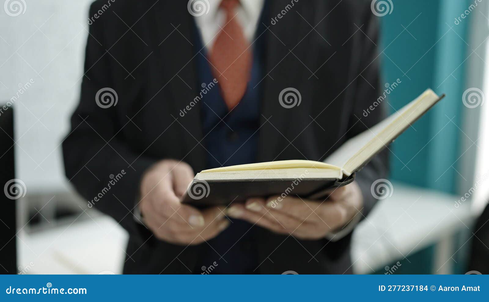 Senior Standing Reading Book at University Classroom Stock Photo ...