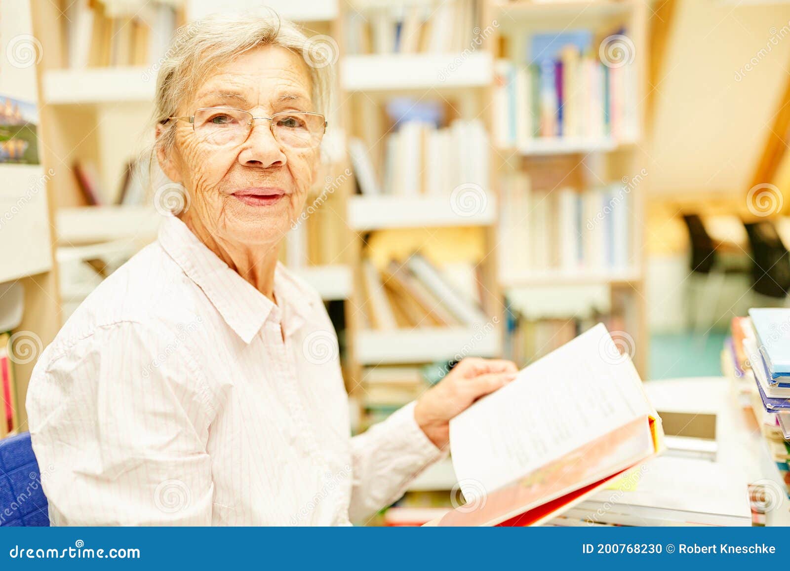 Senior Teacher or Librarian with Book Stock Photo - Image of library ...