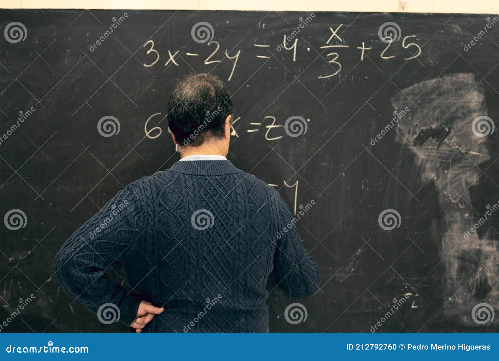 Senior Teacher Writing Equations on a Blackboard in a Classroom Stock ...