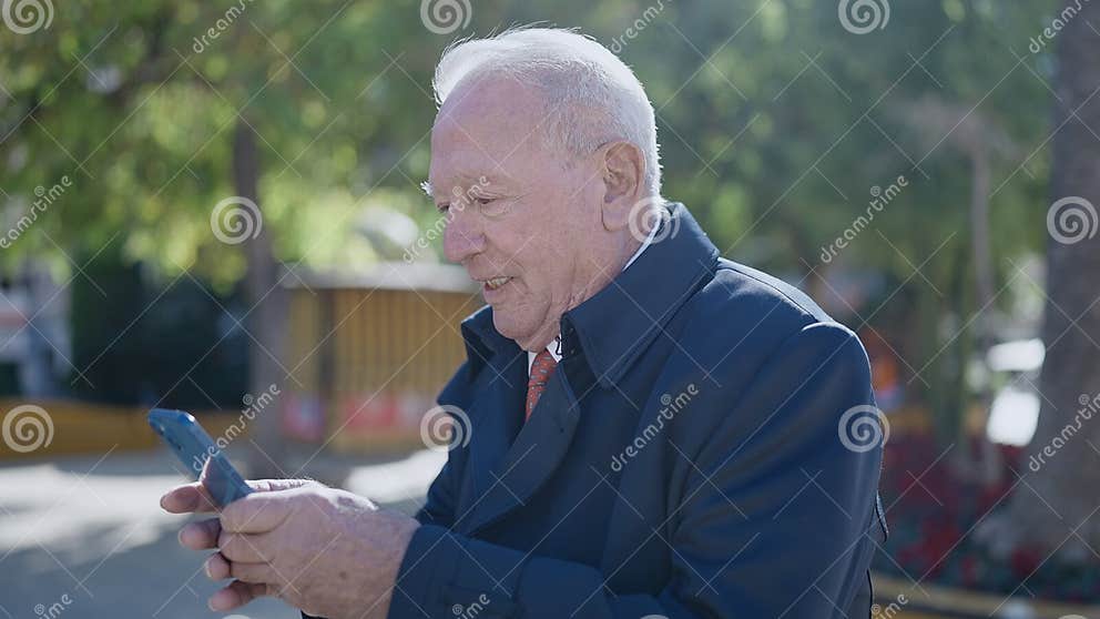 Senior Using Smartphone at Park Stock Photo - Image of cellphone ...