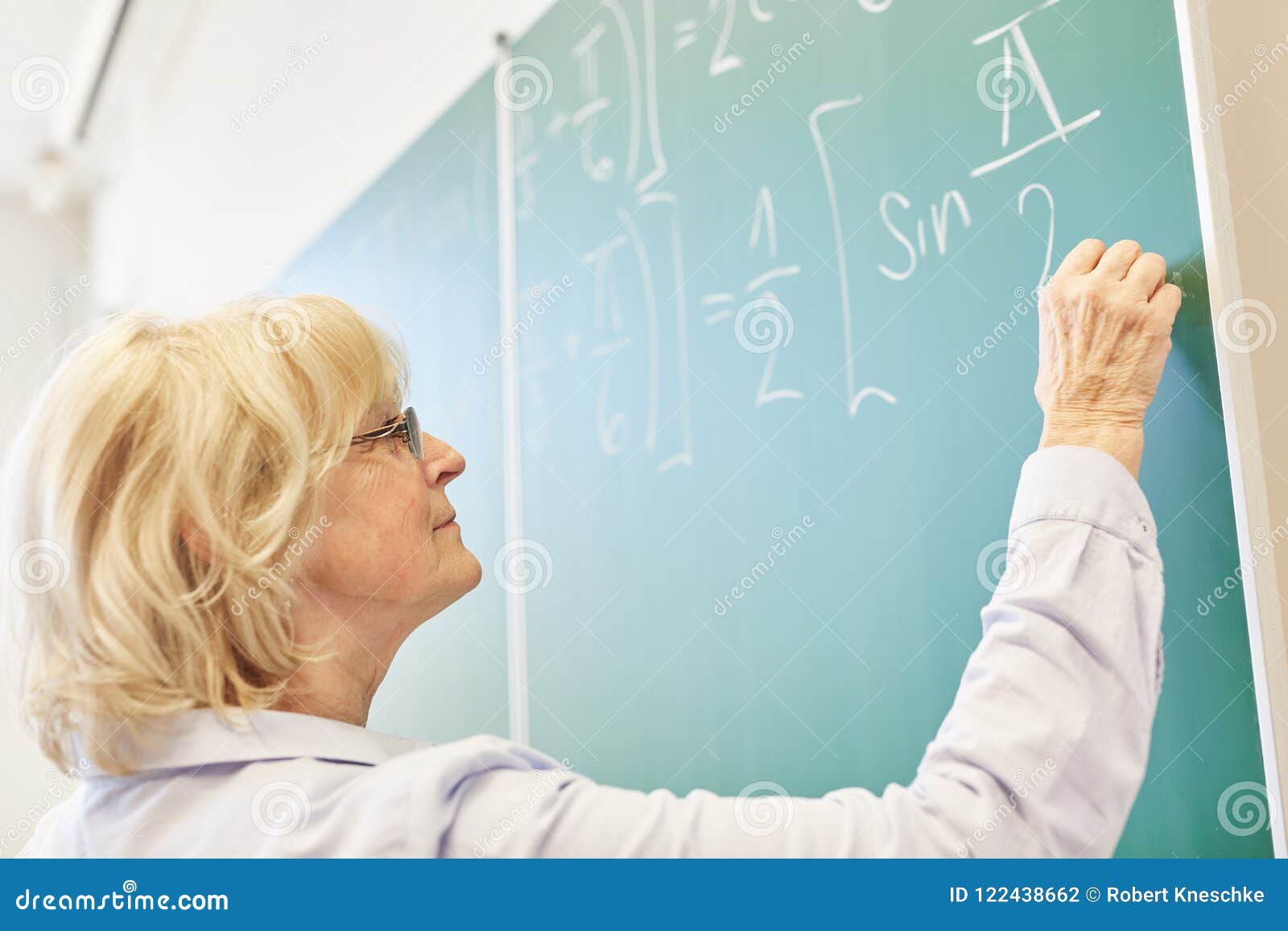 Senior Woman As Teacher Writes on Chalkboard Stock Photo - Image of ... Senior Woman As Teacher Writes on Chalkboard Stock Photo - Image of ...