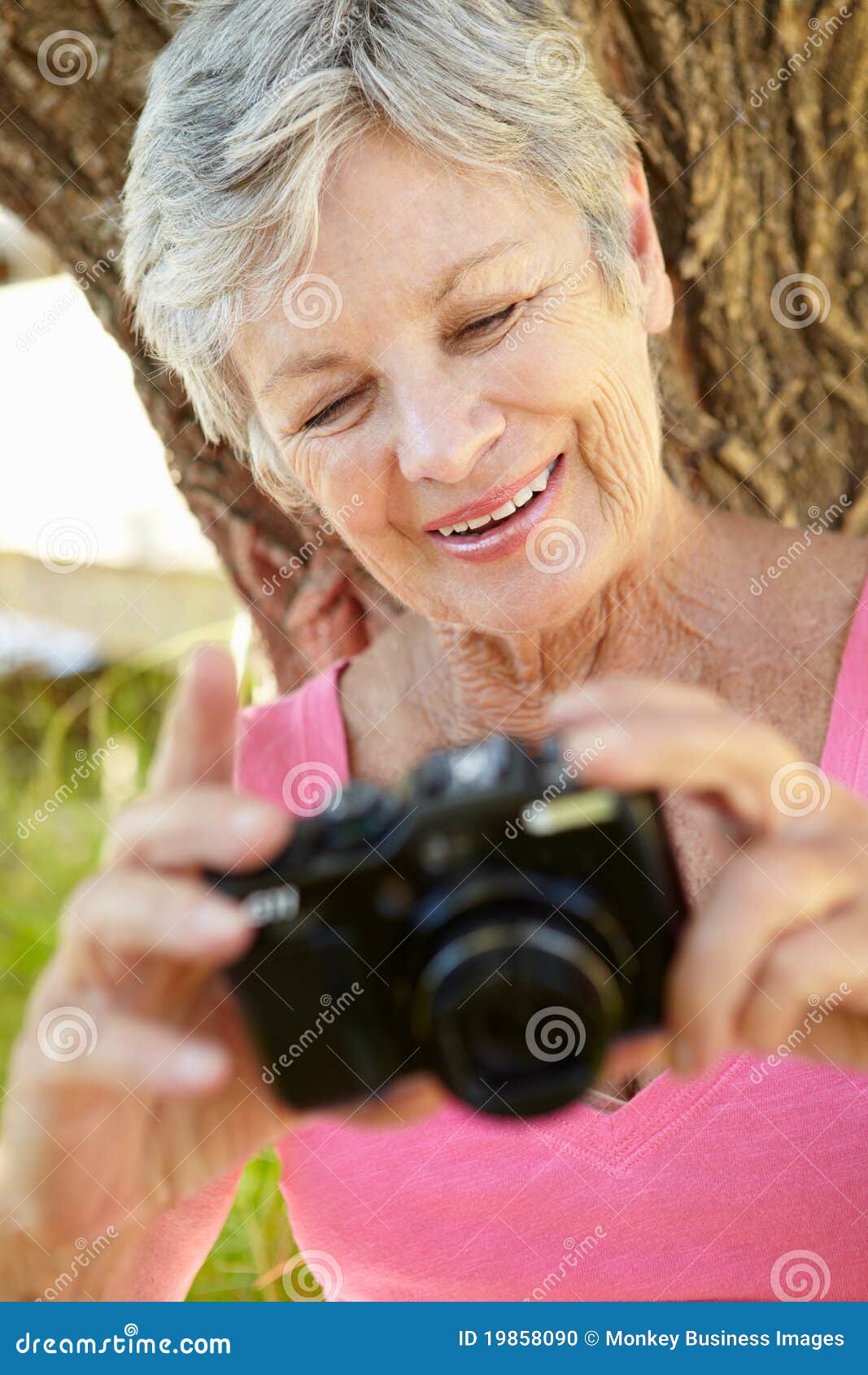 Senior woman with camera stock photo. Image of haired - 19858090