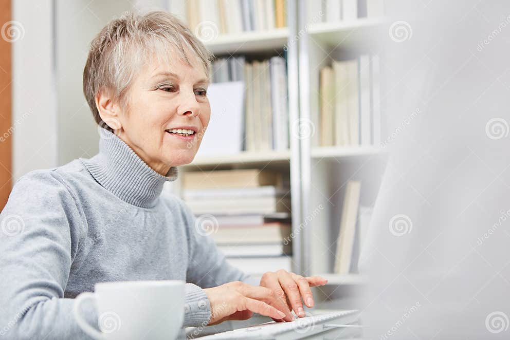 Senior woman with computer stock photo. Image of learn - 103701482
